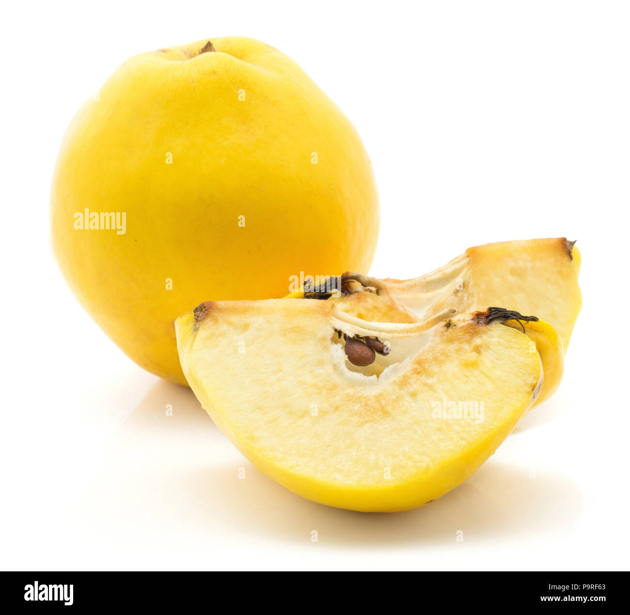 One quince and two slices isolated on white background raw yellow ripe ...