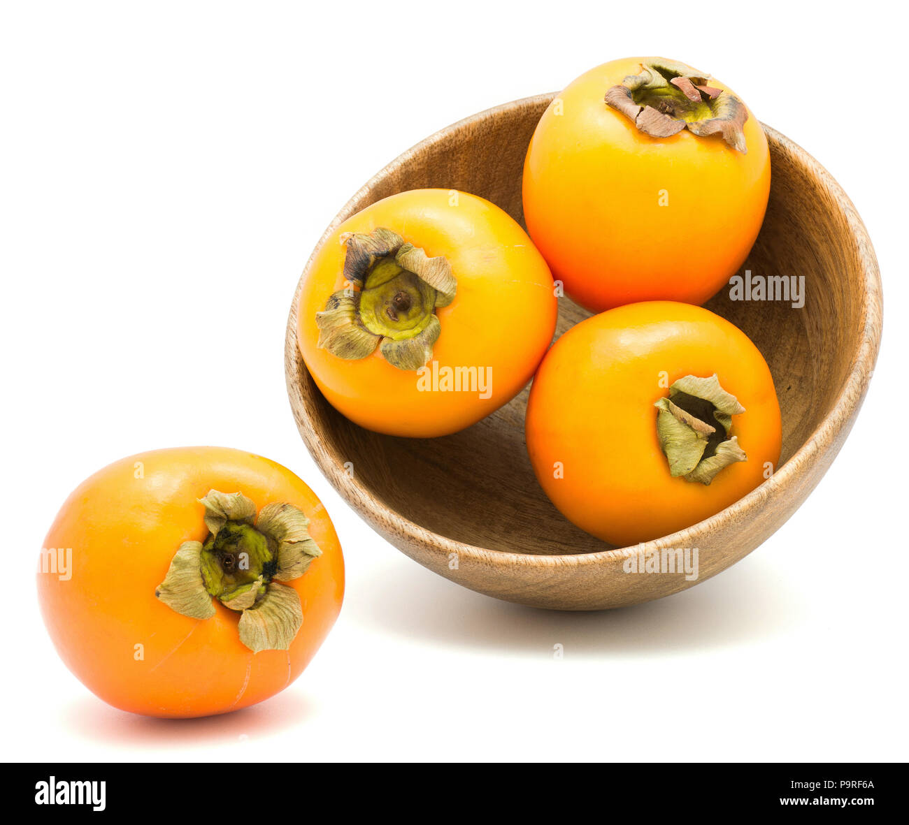 Persimmon Sharon in a wooden bowl isolated on white background Stock ...