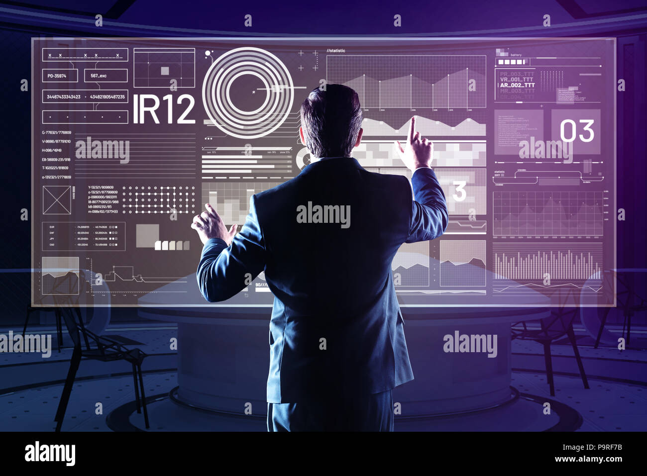 Comparing diagrams. Professional web developer standing in front of his ...