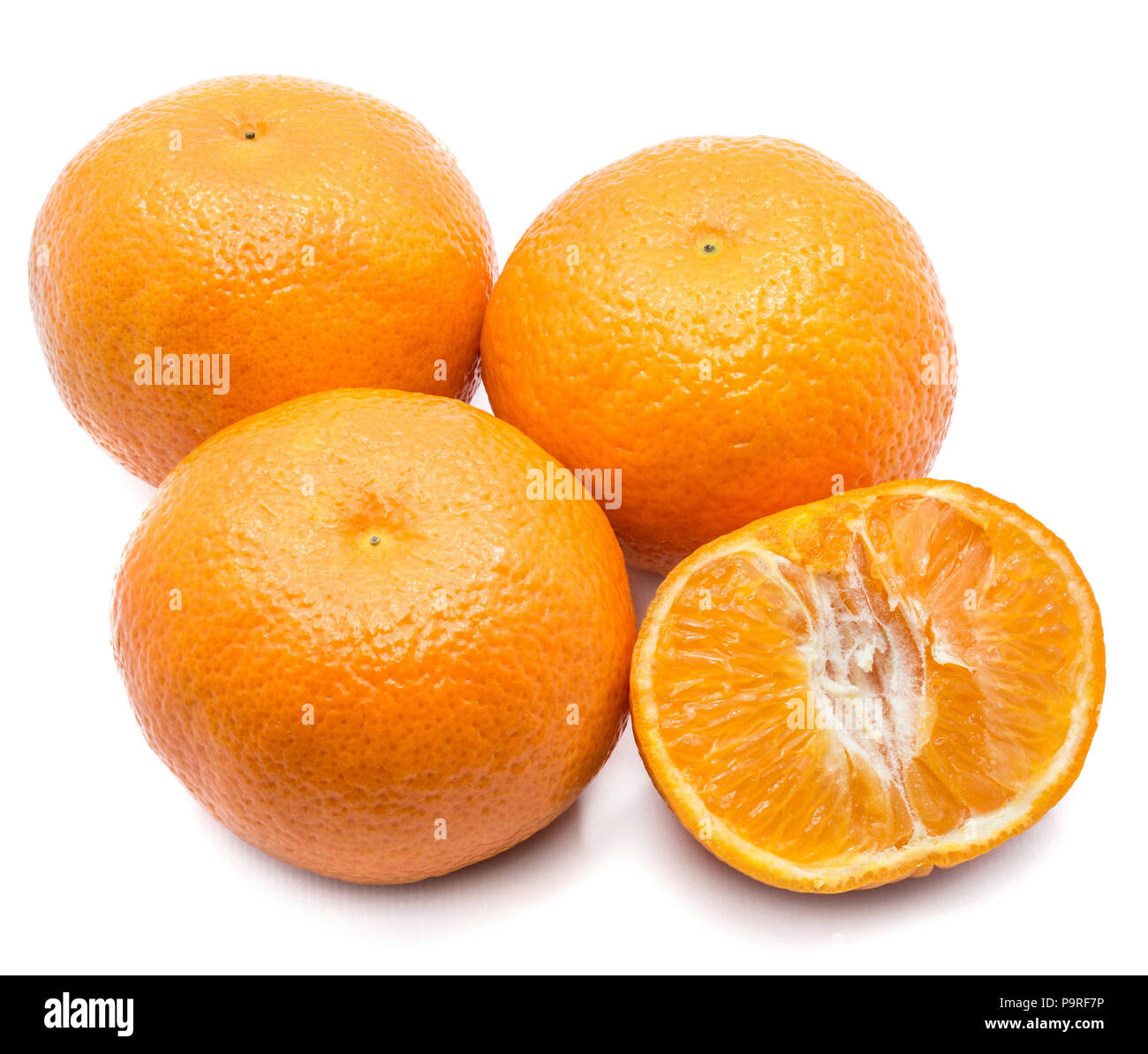 Three whole Clementines and one half isolated on white background Stock ...