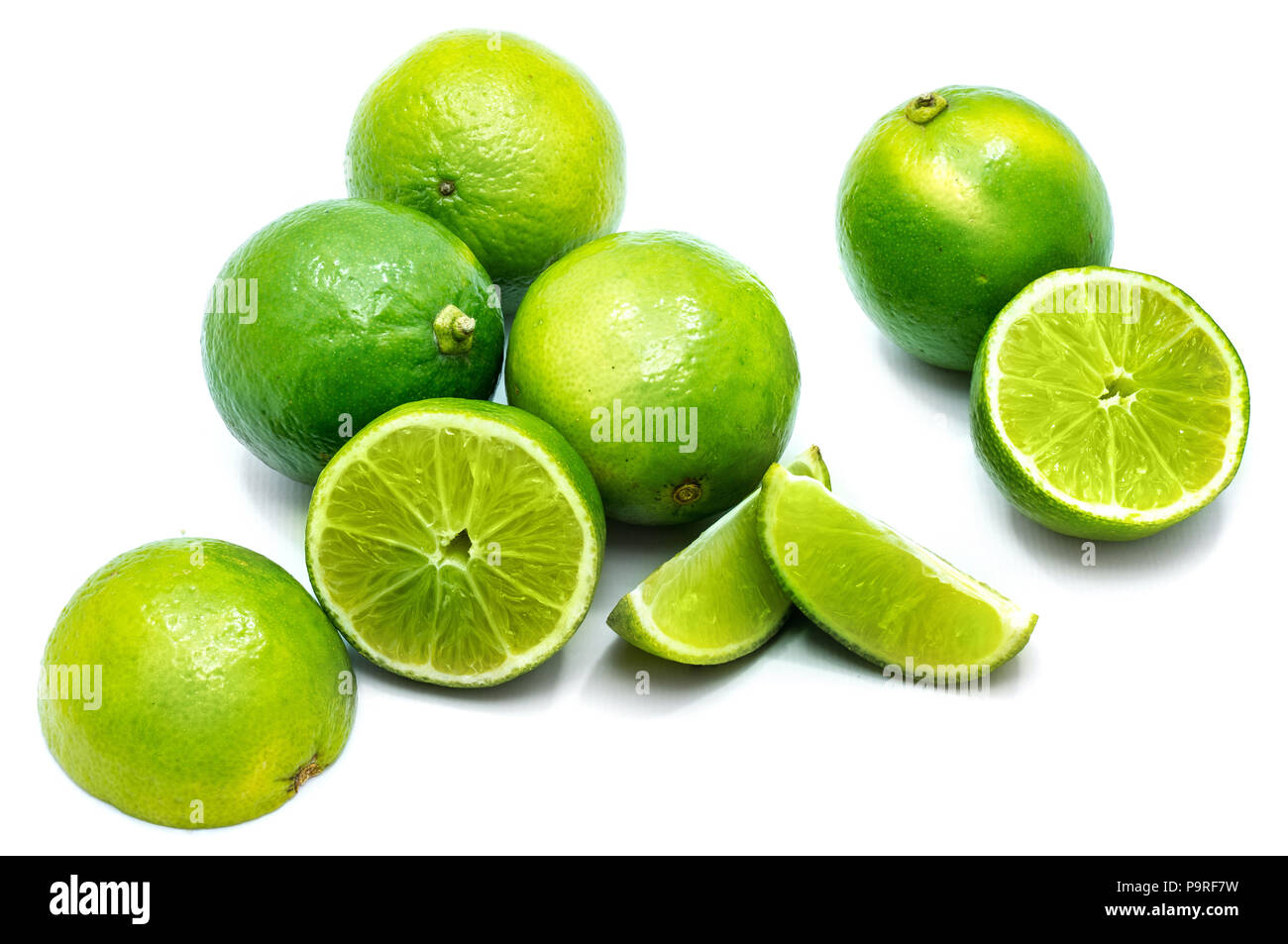 Group of whole, sliced lime and halves isolated on white background ...