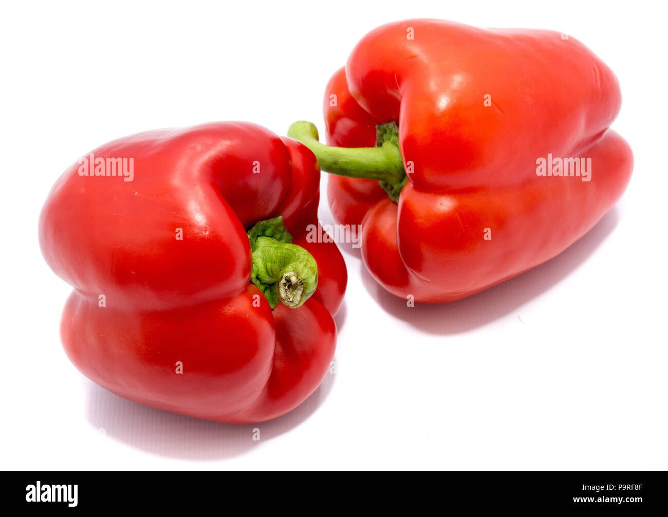 Group of red peppers, one pepper on back, isolated on white background ...