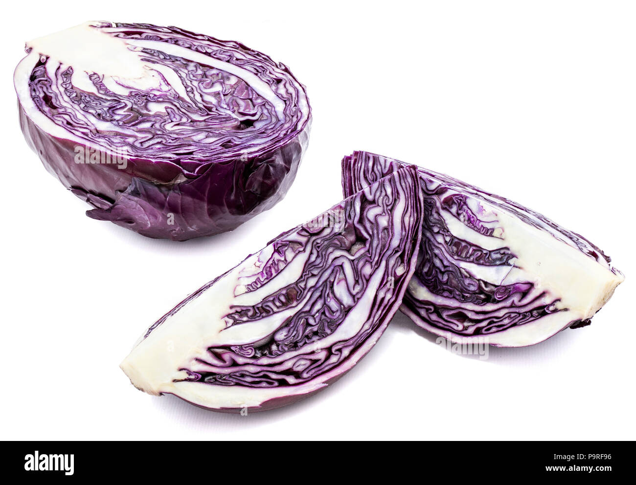 Two sliced quarters of purple cabbage and one half isolated on white ...
