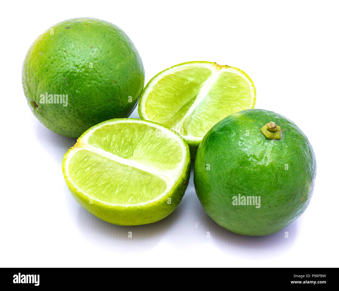 Two whole and two lime halves isolated on white studio background Stock ...