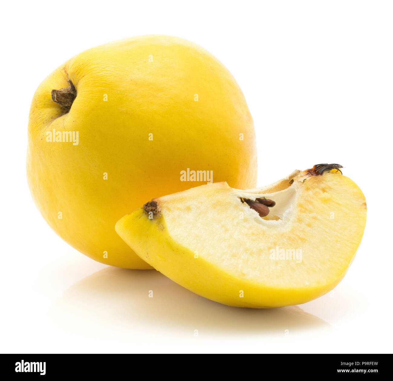 One yellow quince with a slice with seeds isolated on white background ...
