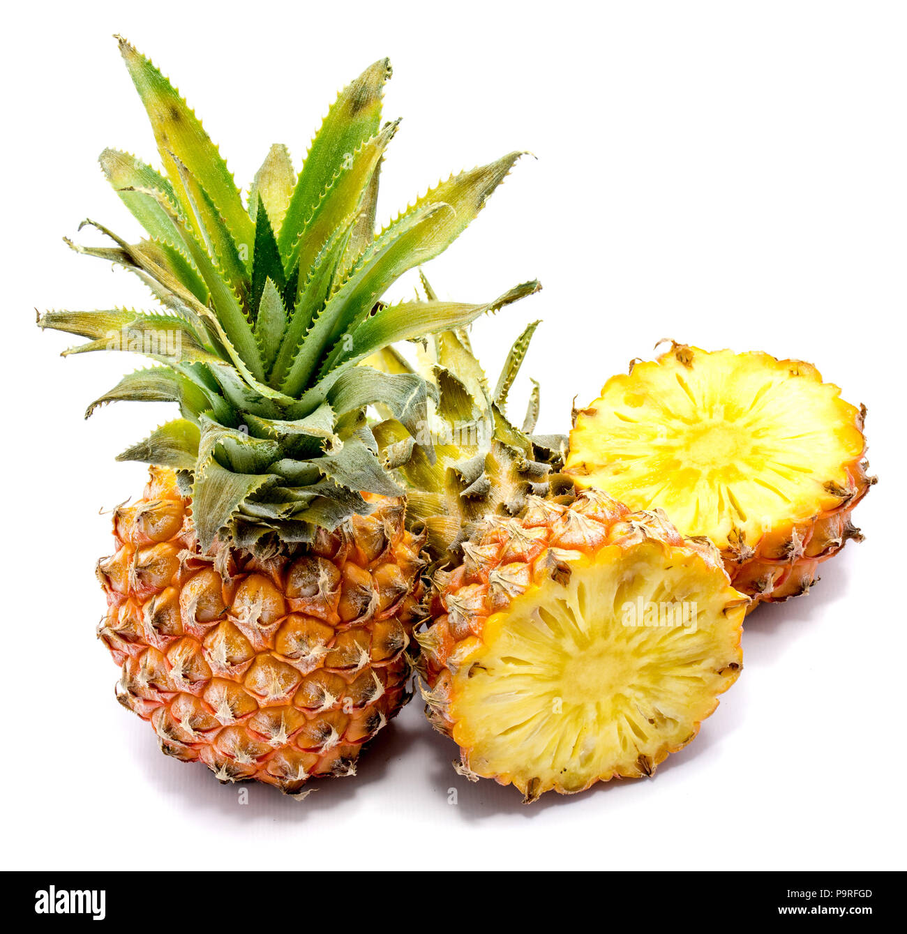 One whole pineapple and its sliced halves isolated on white background ...