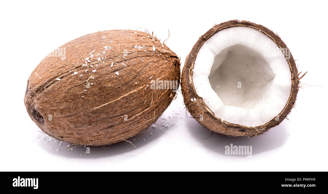 One whole coconut with shavings and one half isolated on white ...