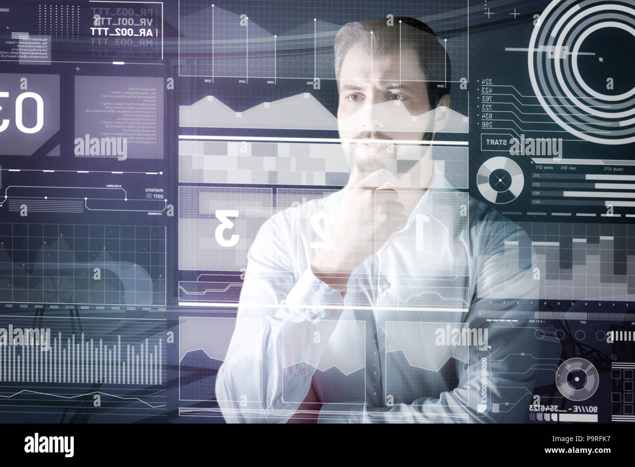 Looking thoughtful. Calm clever database administrator touching his ...