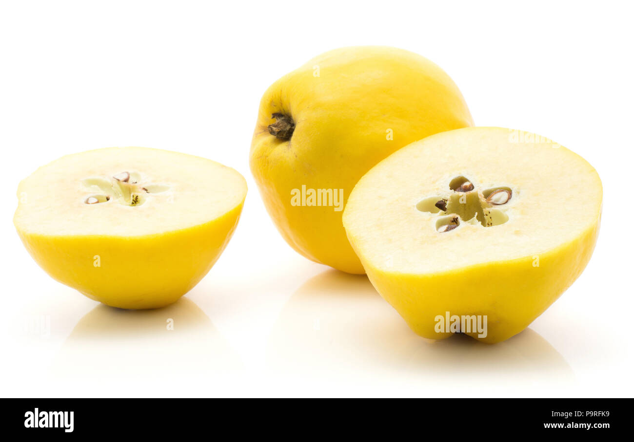 One quince and cut in half isolated on white background raw yellow two ...