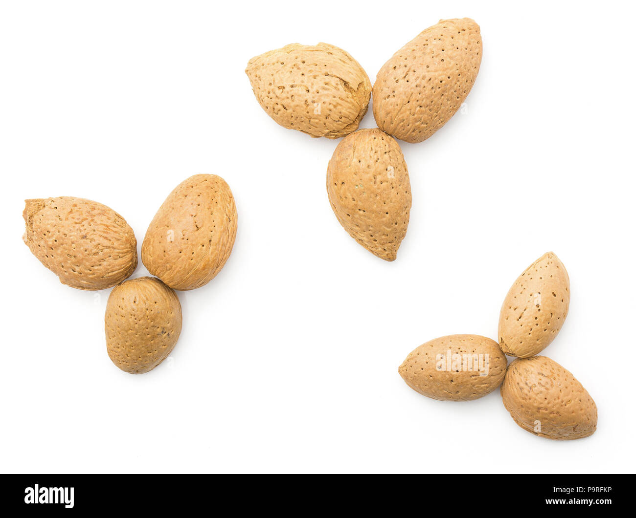 Three almonds top view isolated on white background unshelled nuts ...