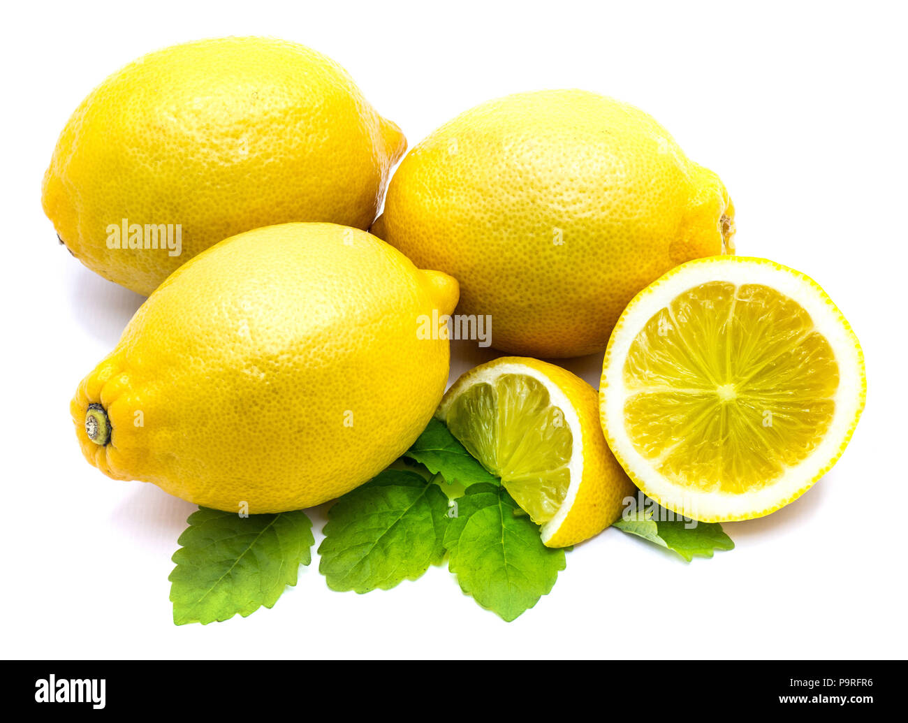 Group of whole yellow lemons, half and slice with fresh lemon balm ...
