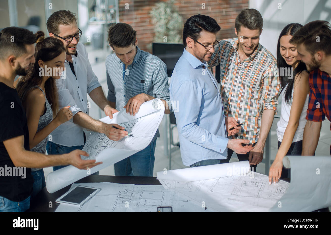 group of designers and architects discussing new sketches Stock Photo ...