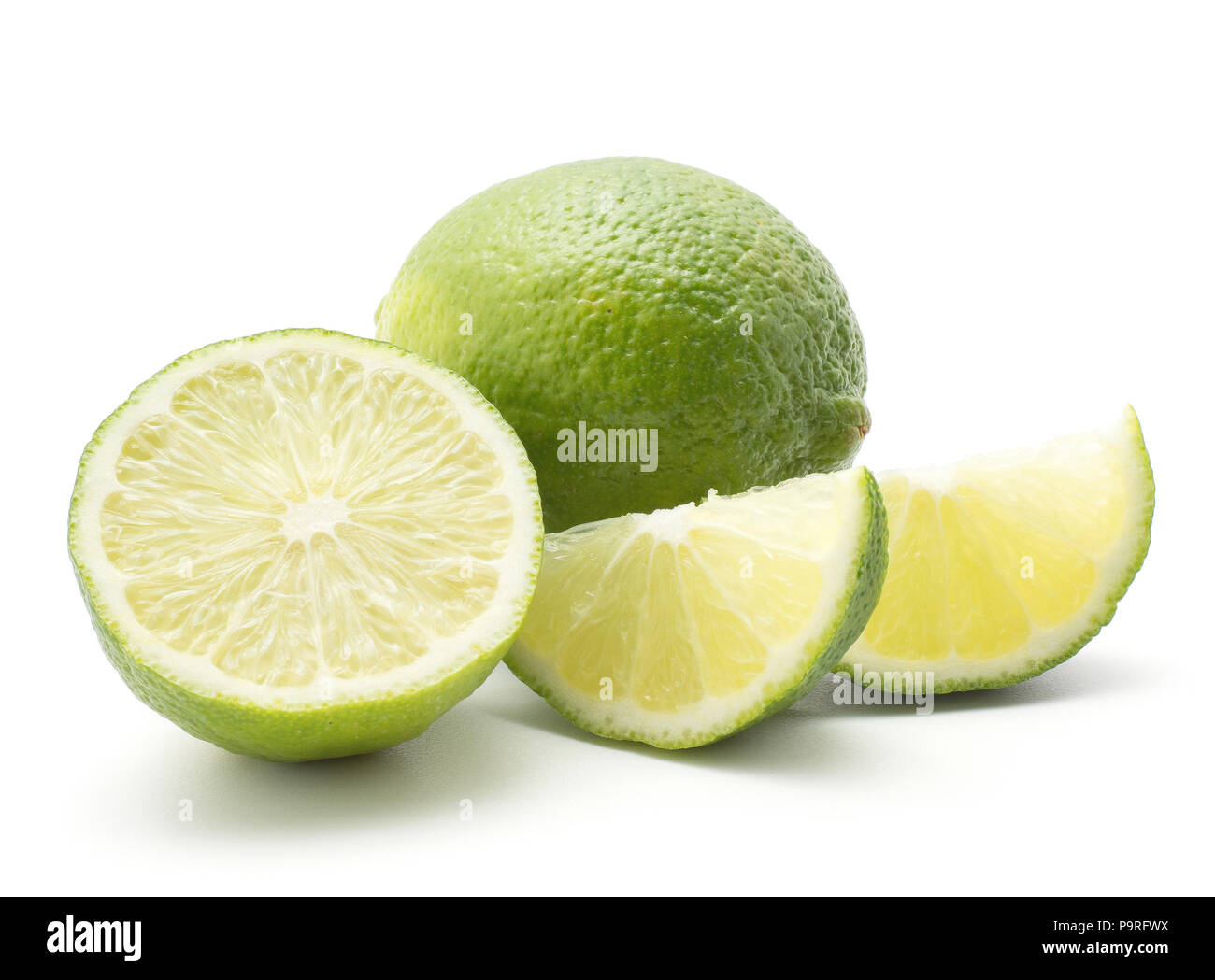 Lime one whole cross section half and two slices isolated on white ...