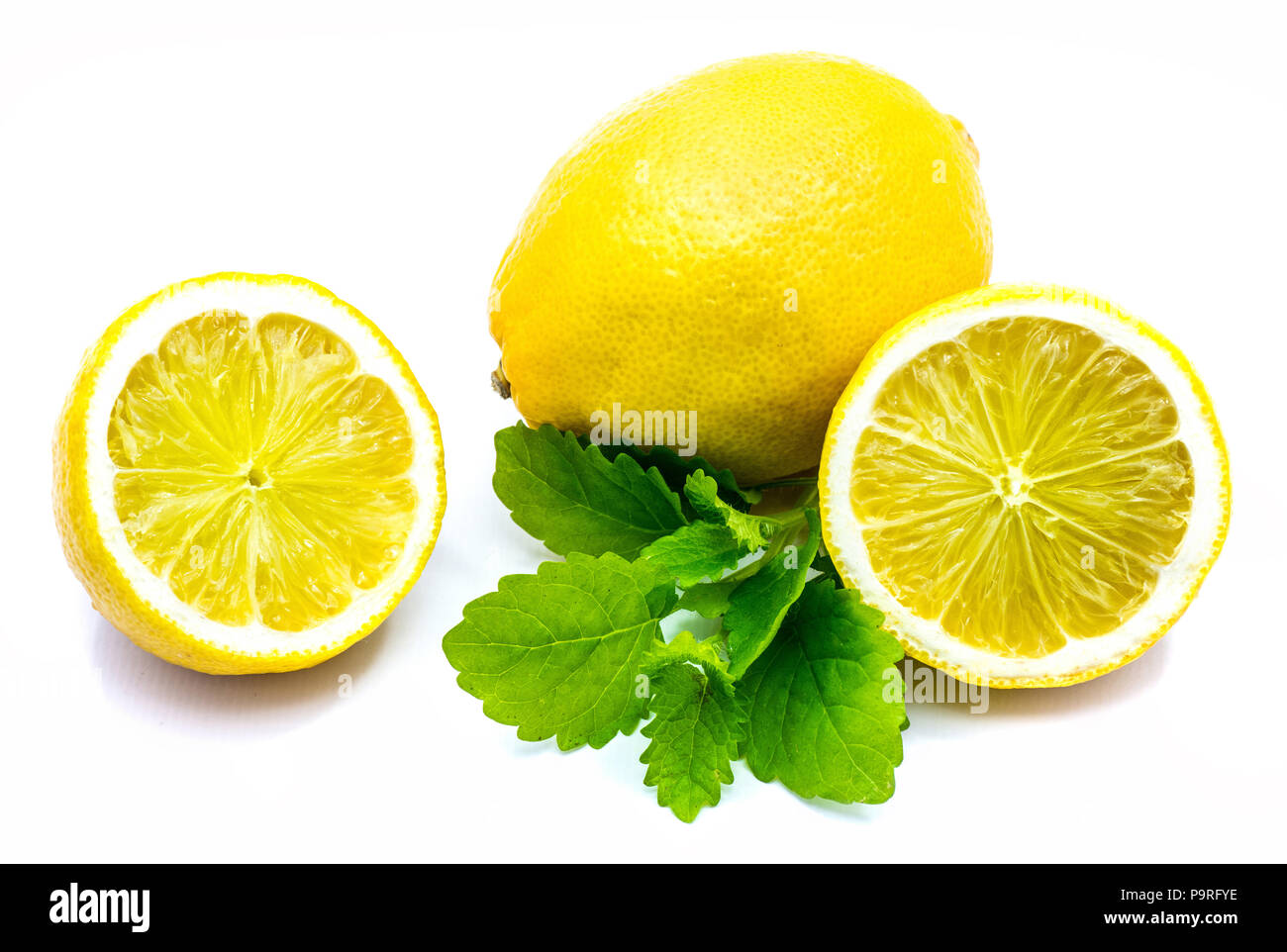 One whole single yellow two cross section halves and fresh green lemon ...