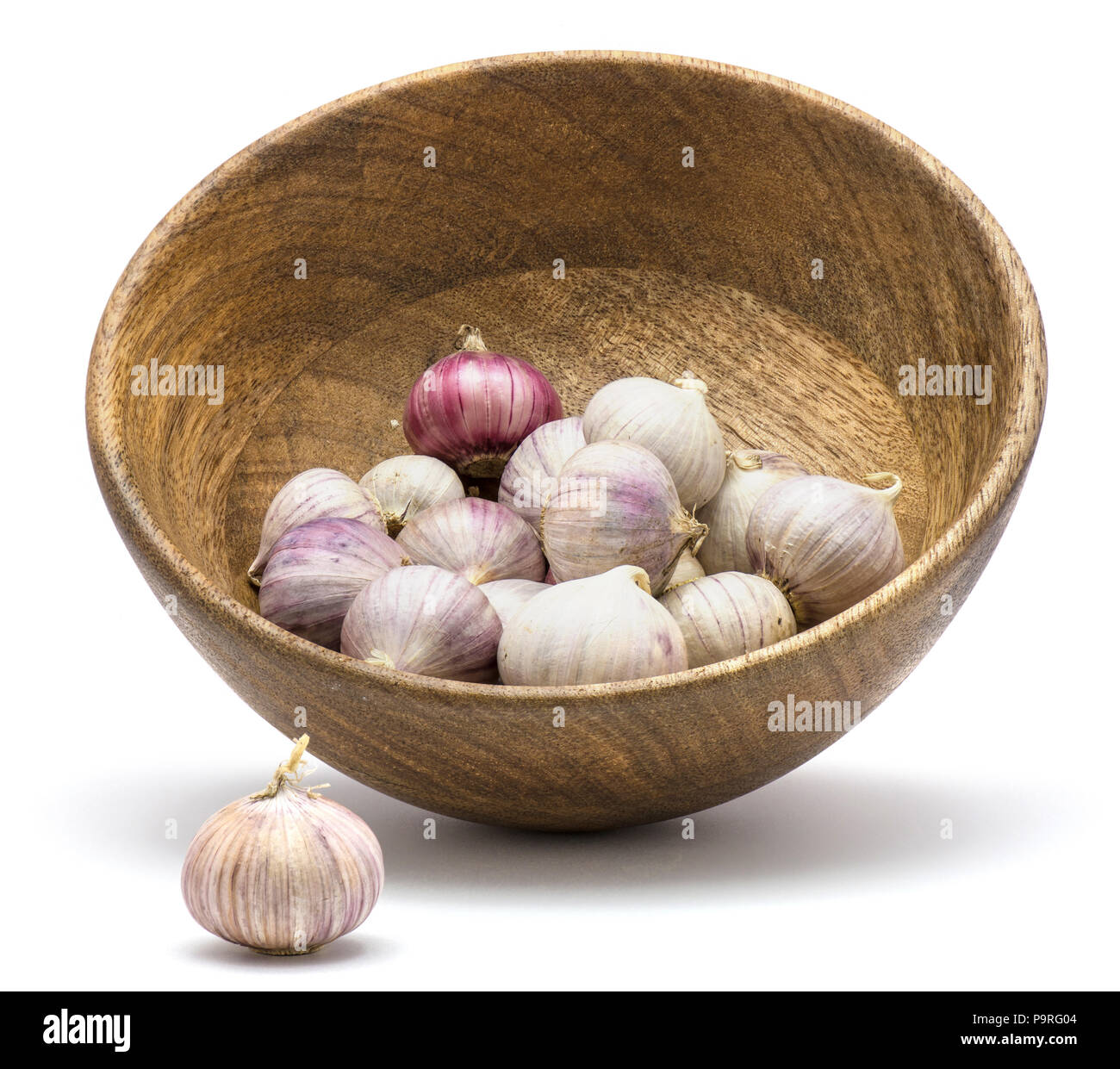 Solo garlic in wooden bowl isolated on white background Stock Photo - Alamy