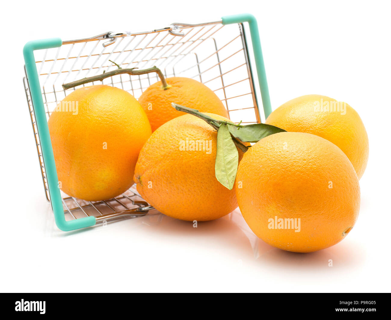 Five oranges with green leaf out a shopping basket isolated on white ...