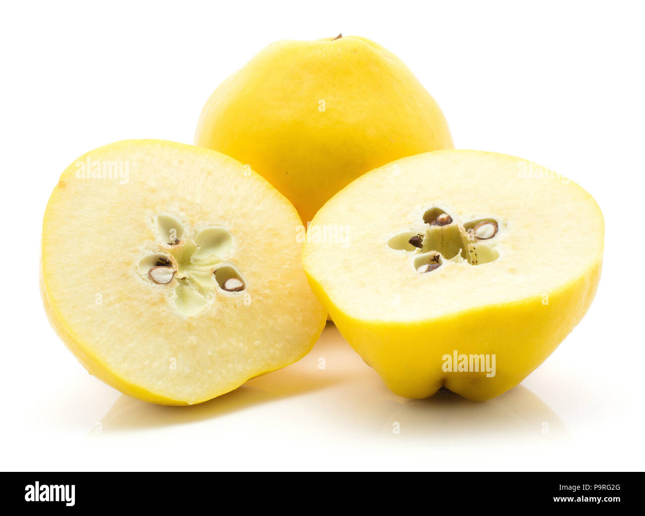 One quince and two cut halves isolated on white background raw yellow ...