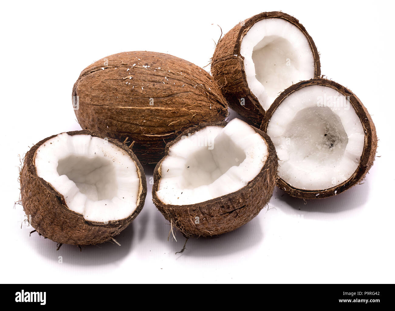 One whole coconut and four halves isolated on white background Stock ...