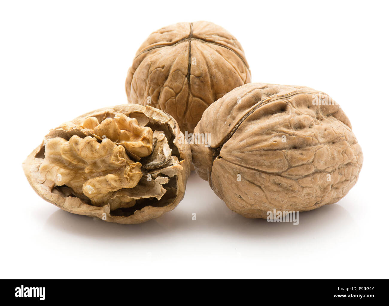 Three walnuts isolated on white background one cracked Stock Photo - Alamy