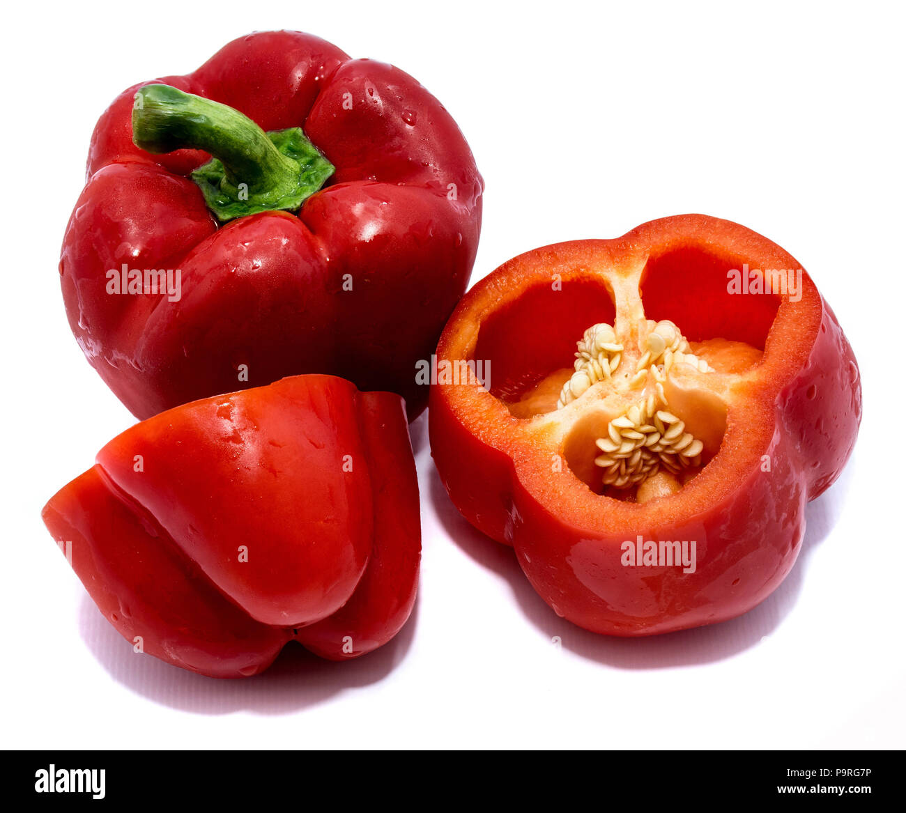 Group of peppers, cut red pepper and whole red isolated on white ...
