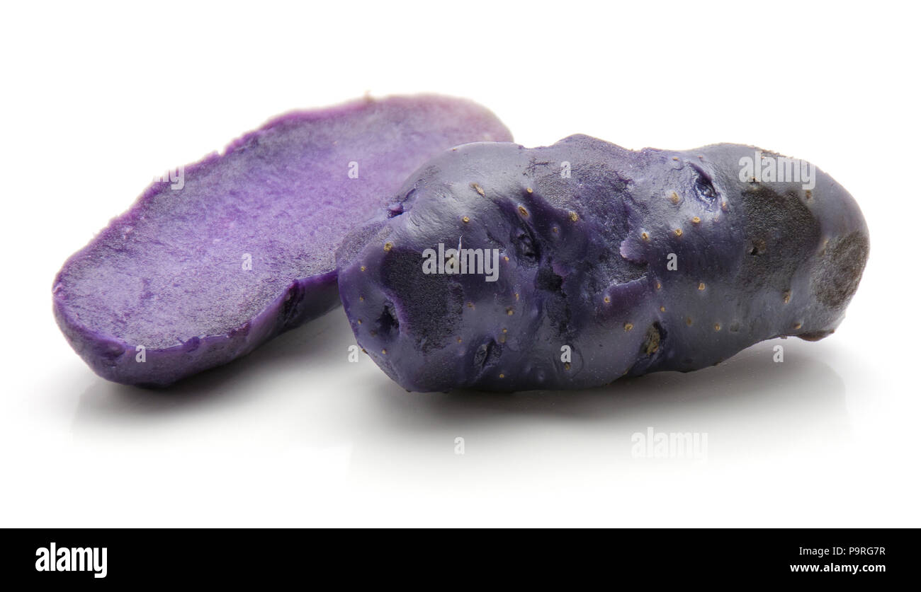 Boiled vitelotte potatoes isolated on white background one peeled and ...