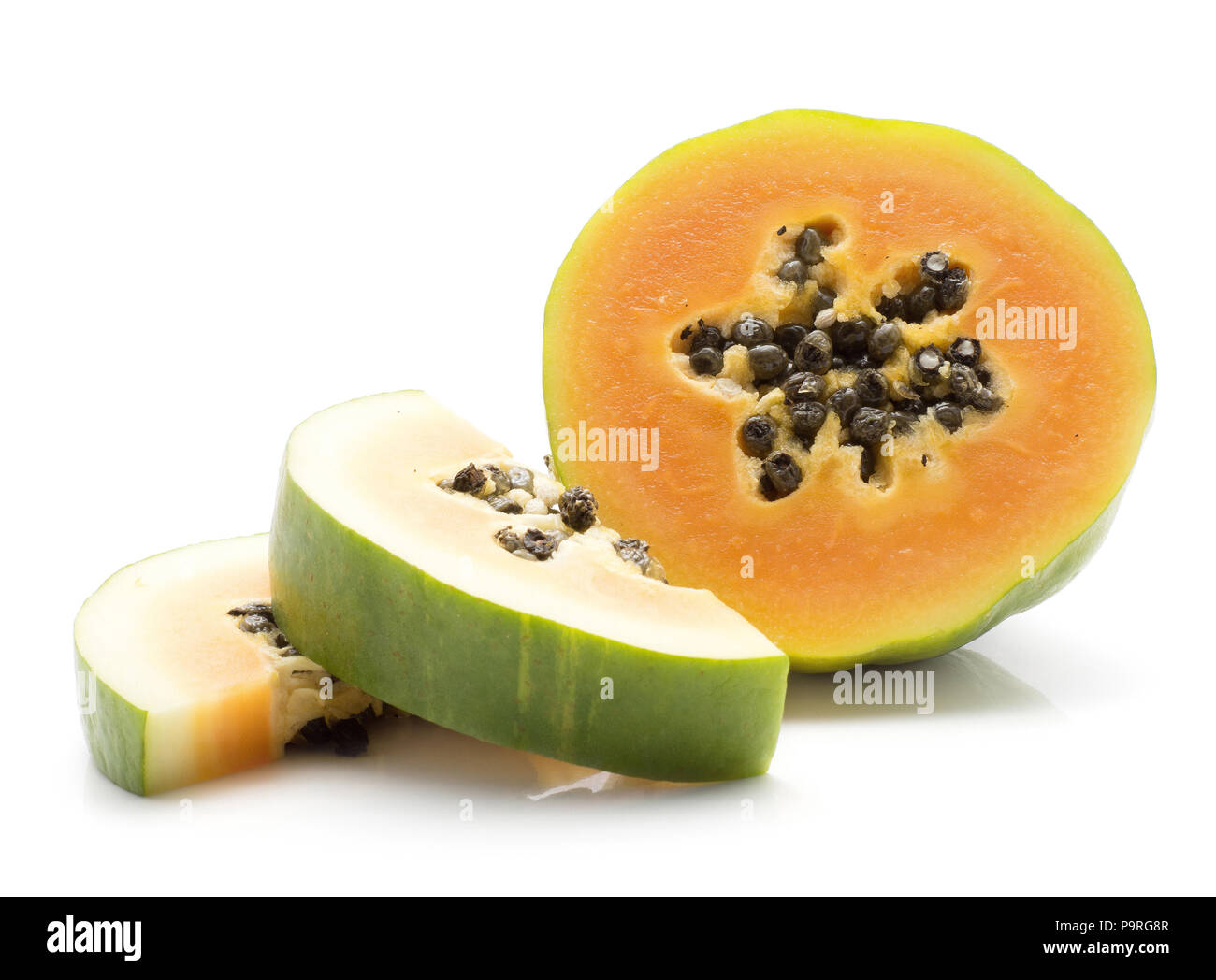 Green papaya (pawpaw, papaw) one half two slices black seeds isolated ...