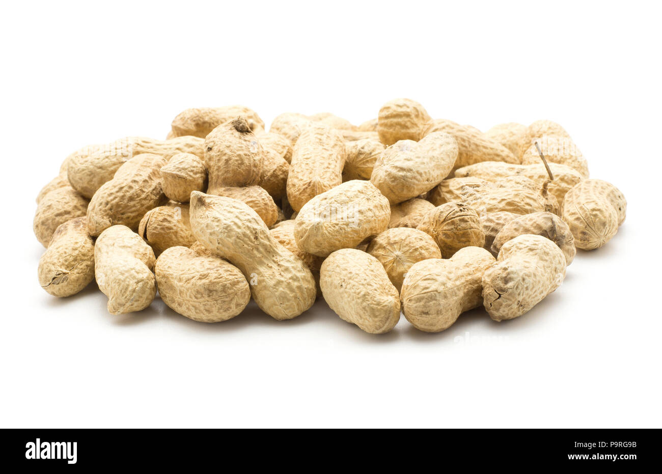 Unshelled raw peanuts heap isolated on white background Stock Photo - Alamy
