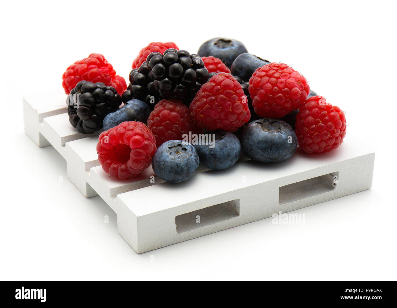 Berries on pallet isolated on white background blackberry blueberry and ...