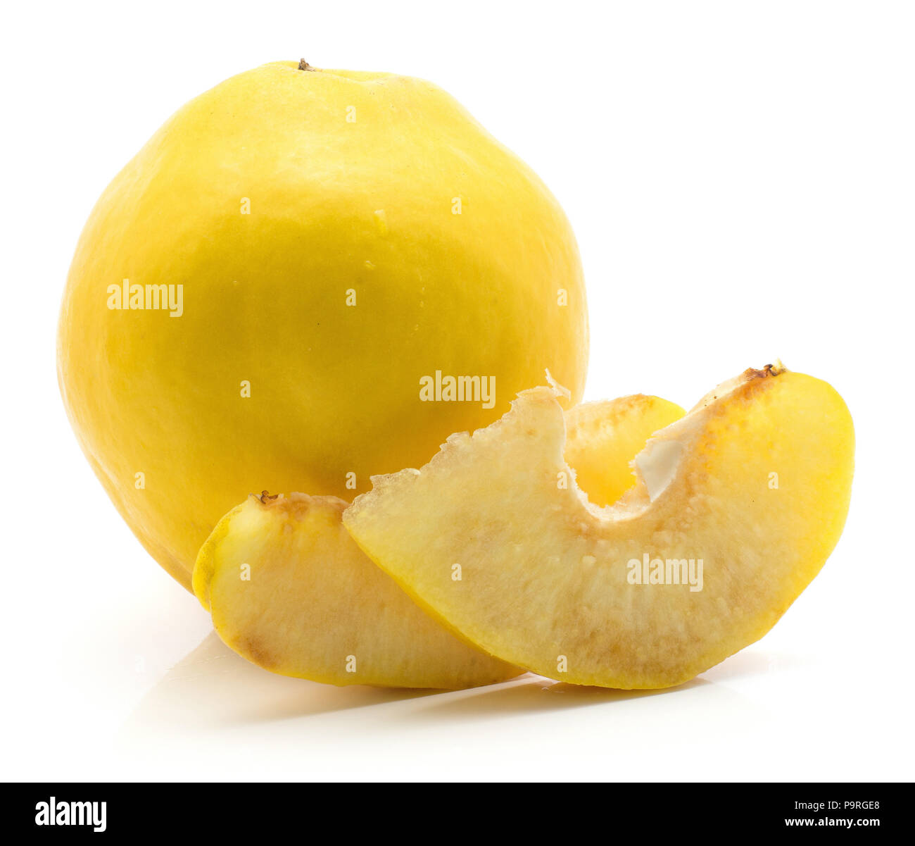 One yellow quince with two slices without seeds isolated on white ...