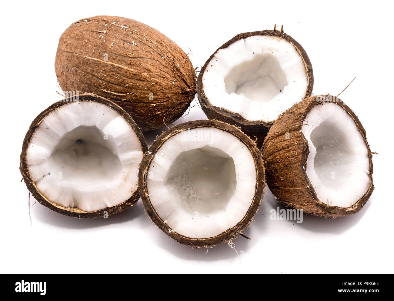 One whole coconut and four halves isolated on white background Stock ...