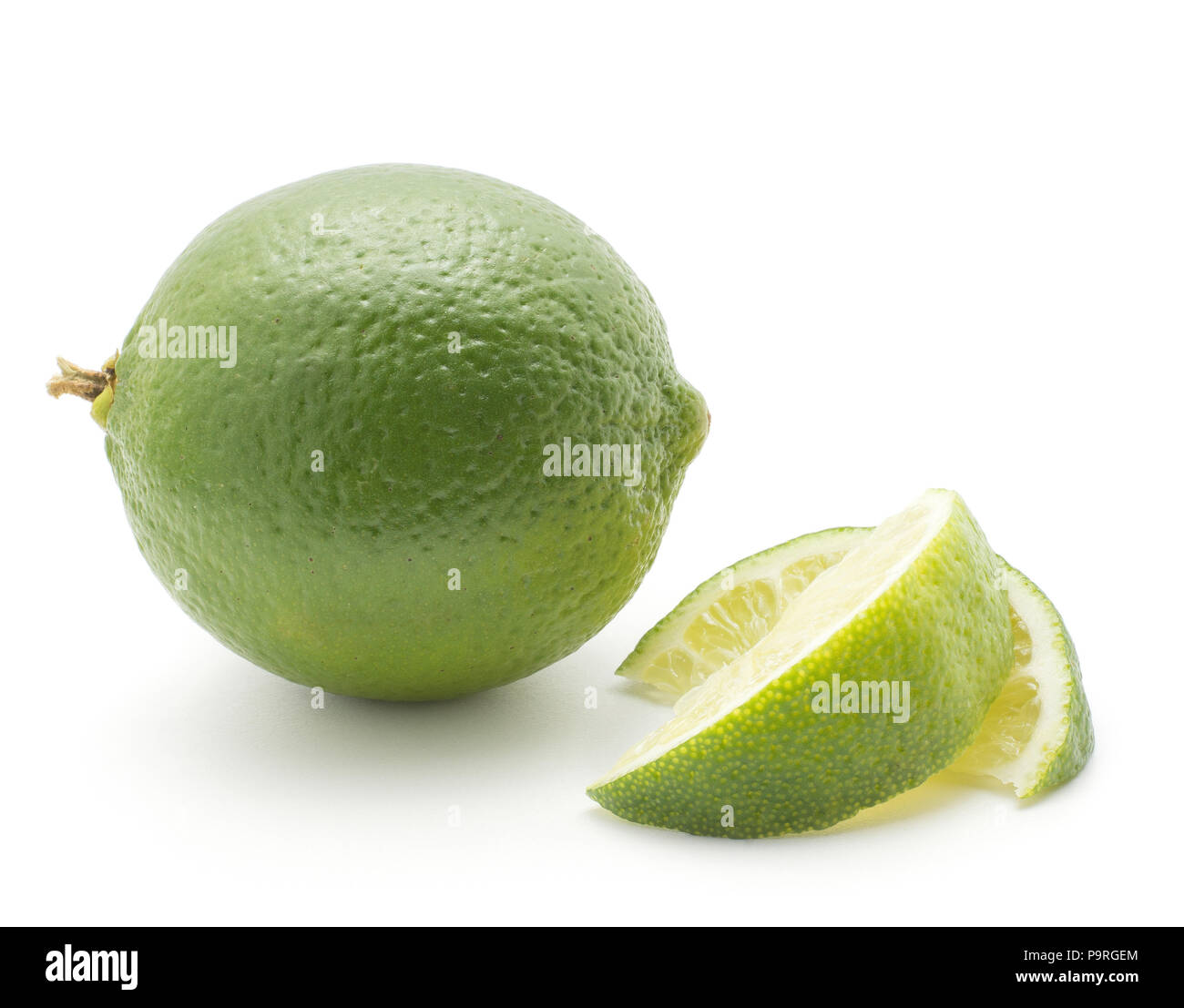 One lime two slices isolated on white background Stock Photo - Alamy
