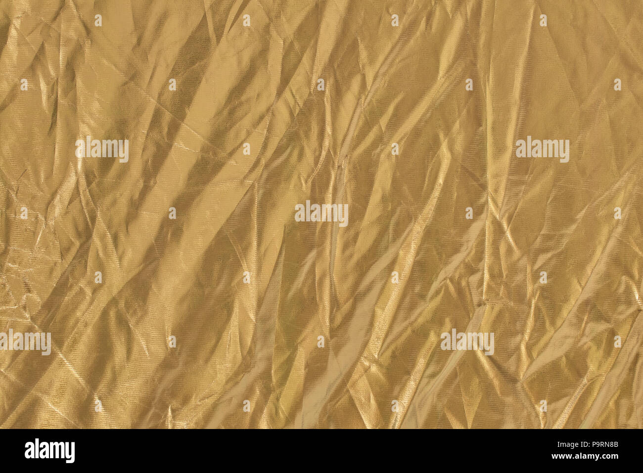 Golden textile background. Fabric of yellow color Stock Photo - Alamy