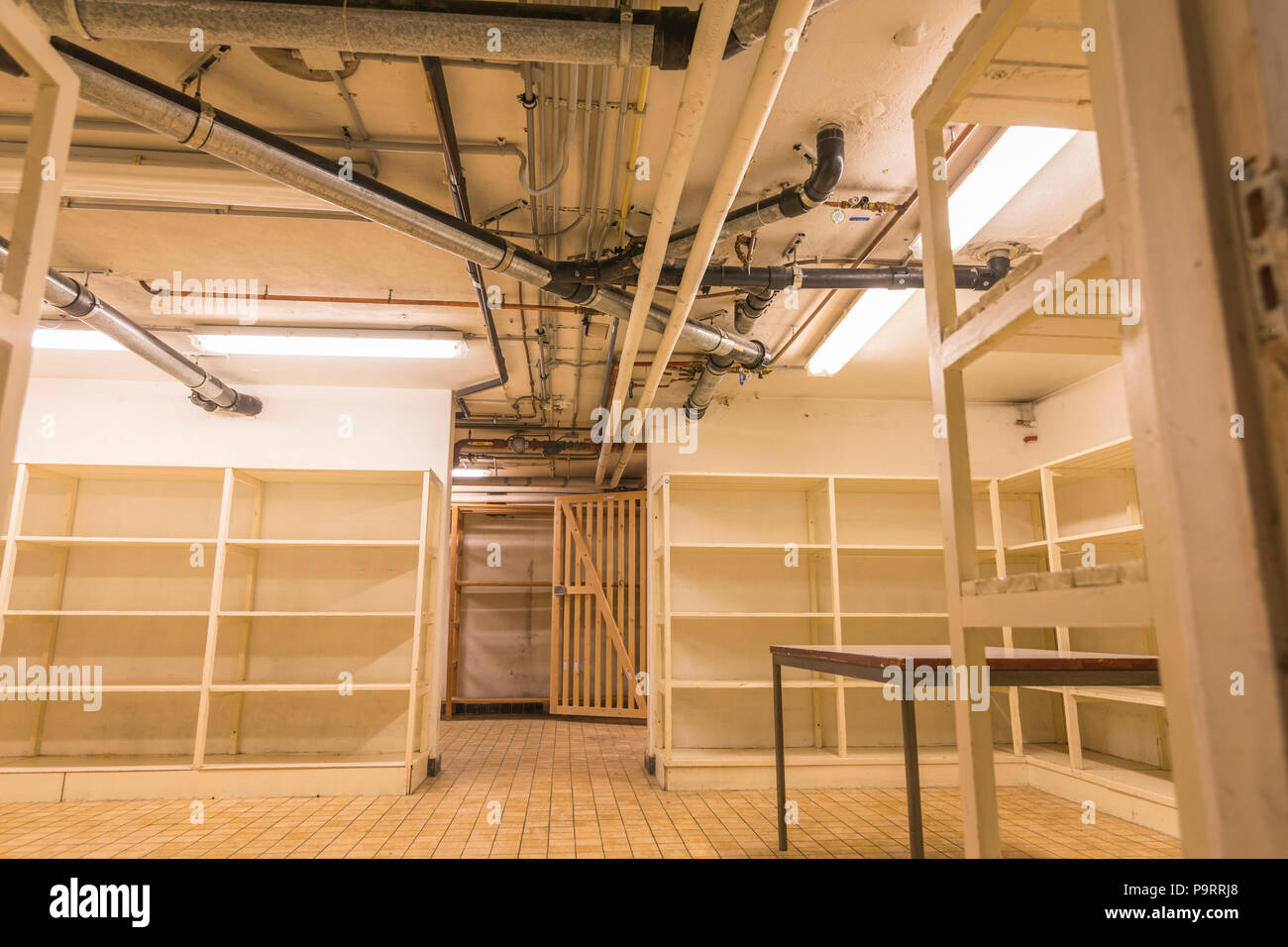 Big white cellar with empty shelves Stock Photo - Alamy