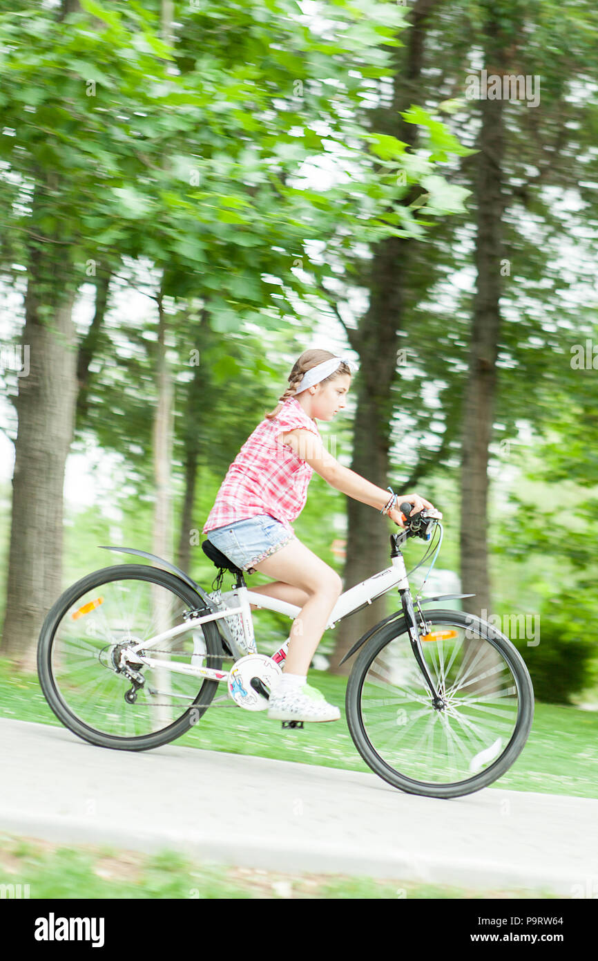Girl riding her bicycle on park trails Stock Photo - Alamy