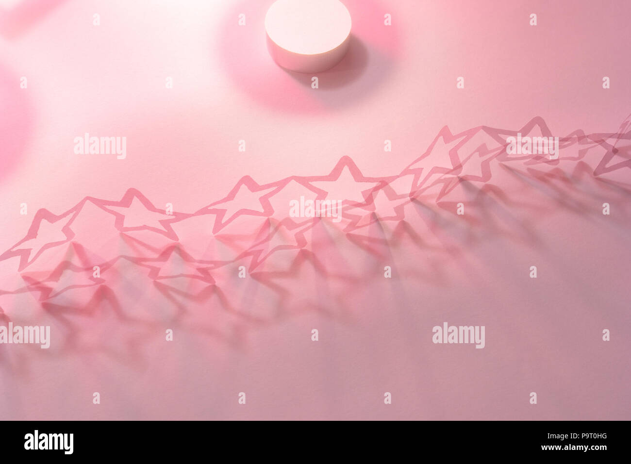 Paper cut star chains with shadows, coming from the candle light and a ...