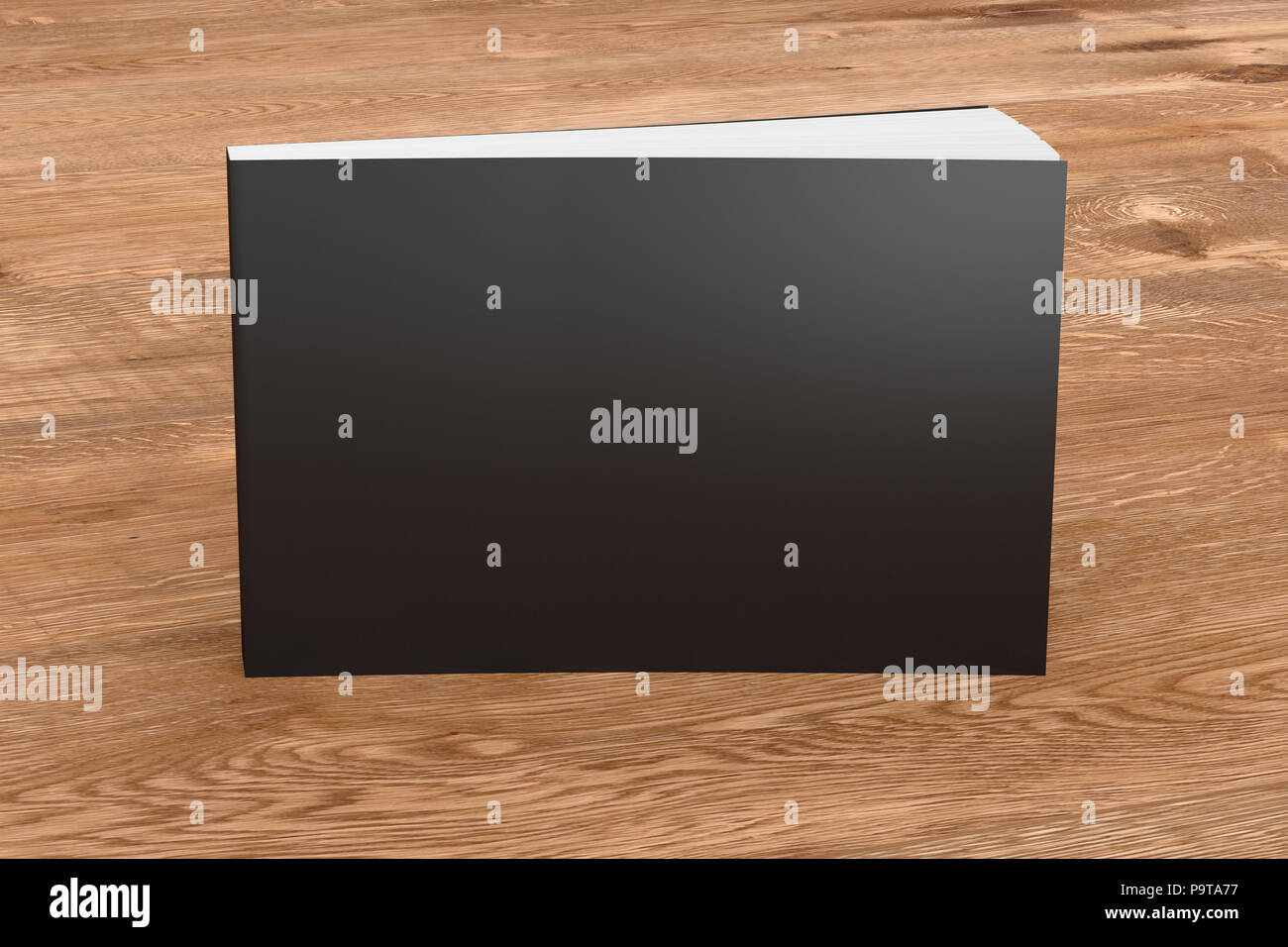 Blank black horizontal soft cover book standing on wooden background ...