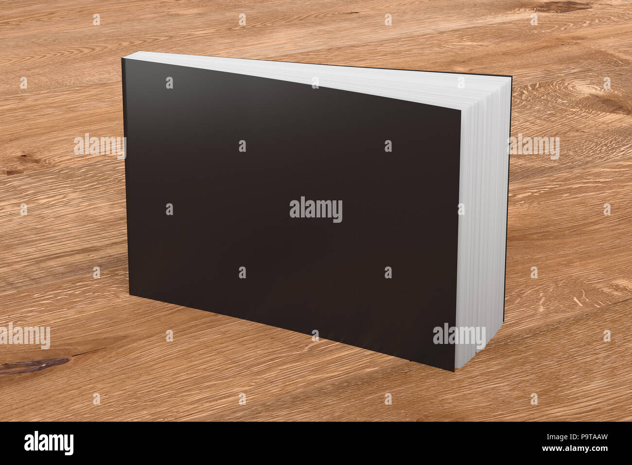 Blank black horizontal soft cover book standing on wooden background ...