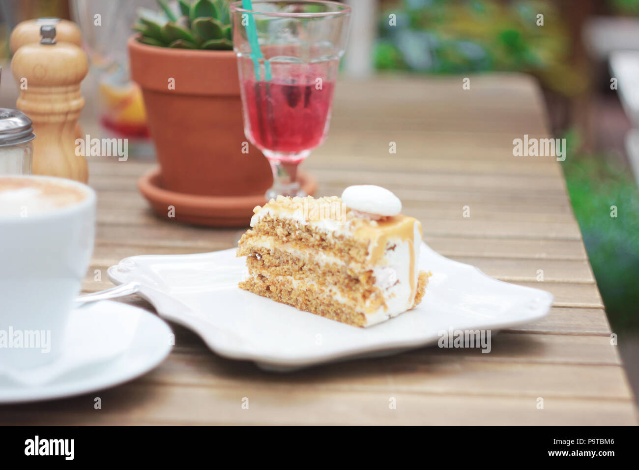 The piece of cake on table of summer terrace in cafe, picnic, set table ...
