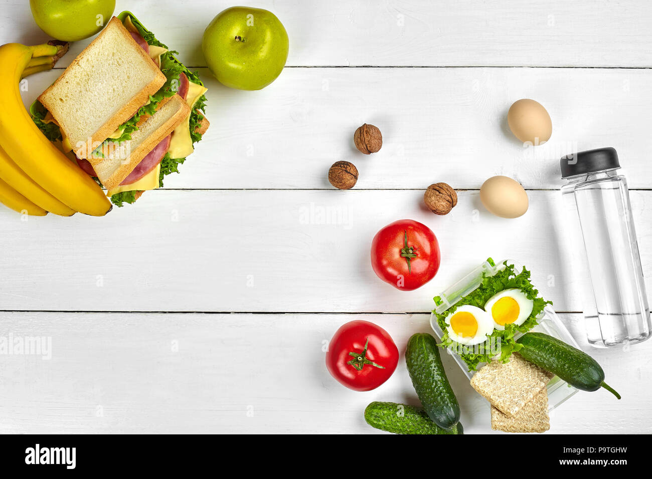 Lunch. Sandwich and fresh vegetables, bottle of water, nuts and fruits ...