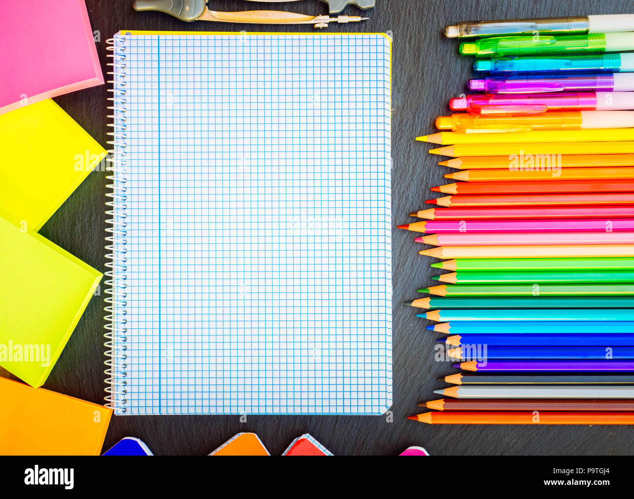 Back to school pencils and pens rainbow and ruled notebook, retro toned ...