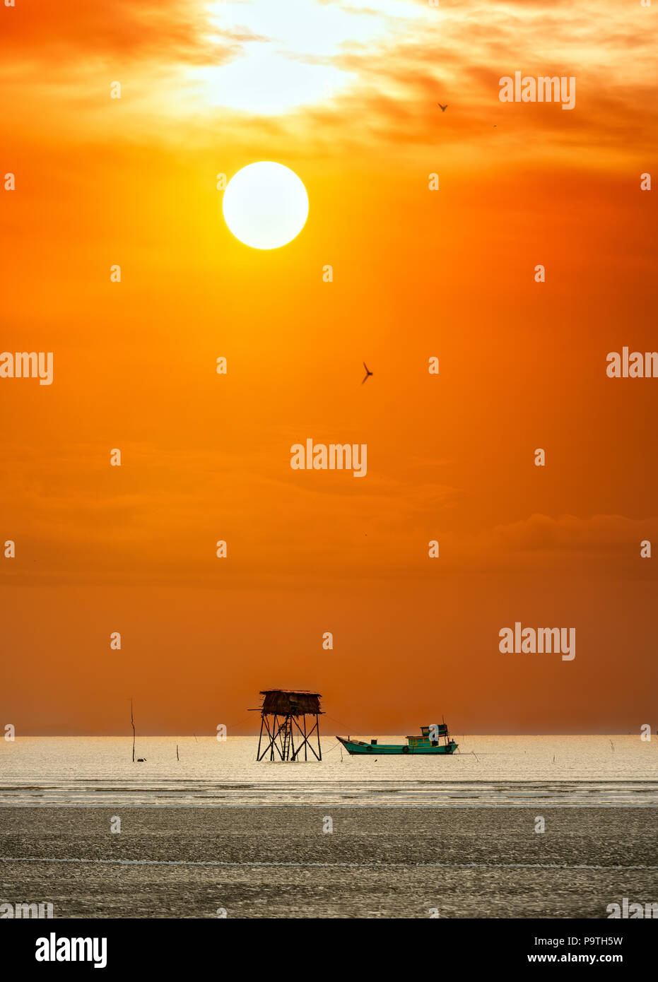 Dawn on the beach with a guardhouse beside the boat as a means to ...