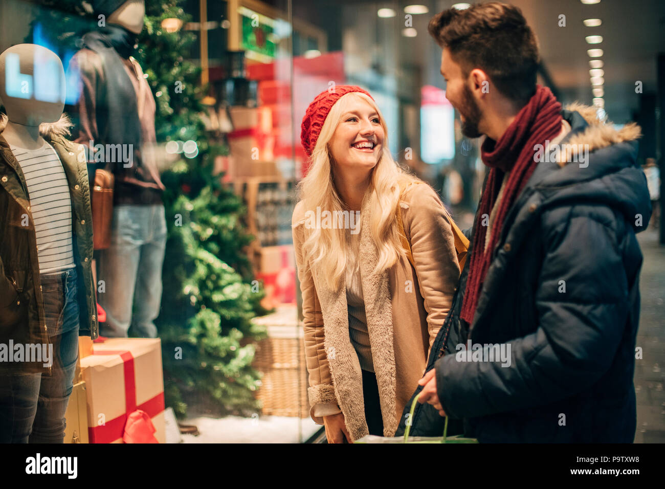 Side view of two mid-adult people window shopping at chirtsmas time ...