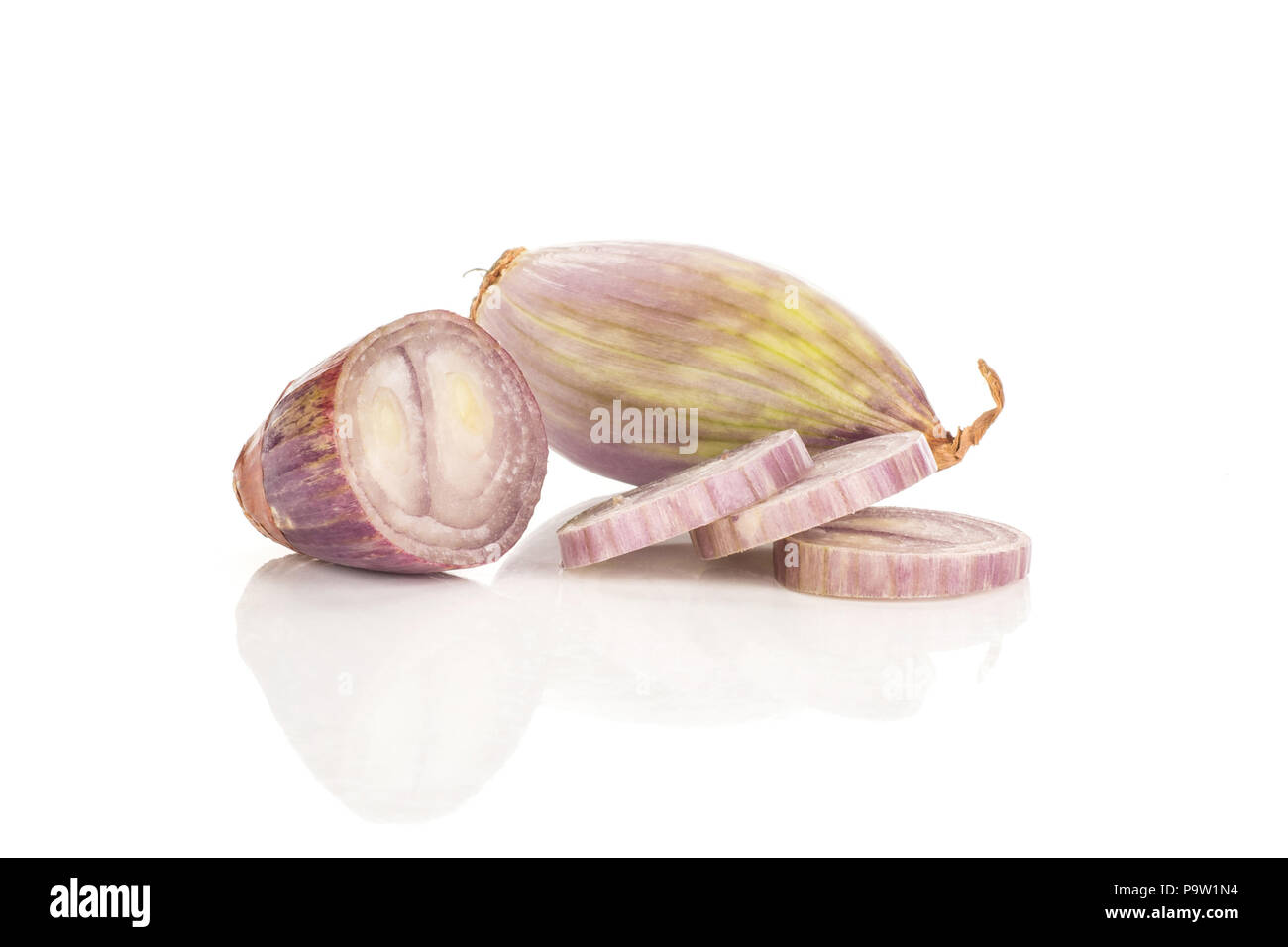 Sliced shallot one peeled with a half and three ring slices isolated on ...