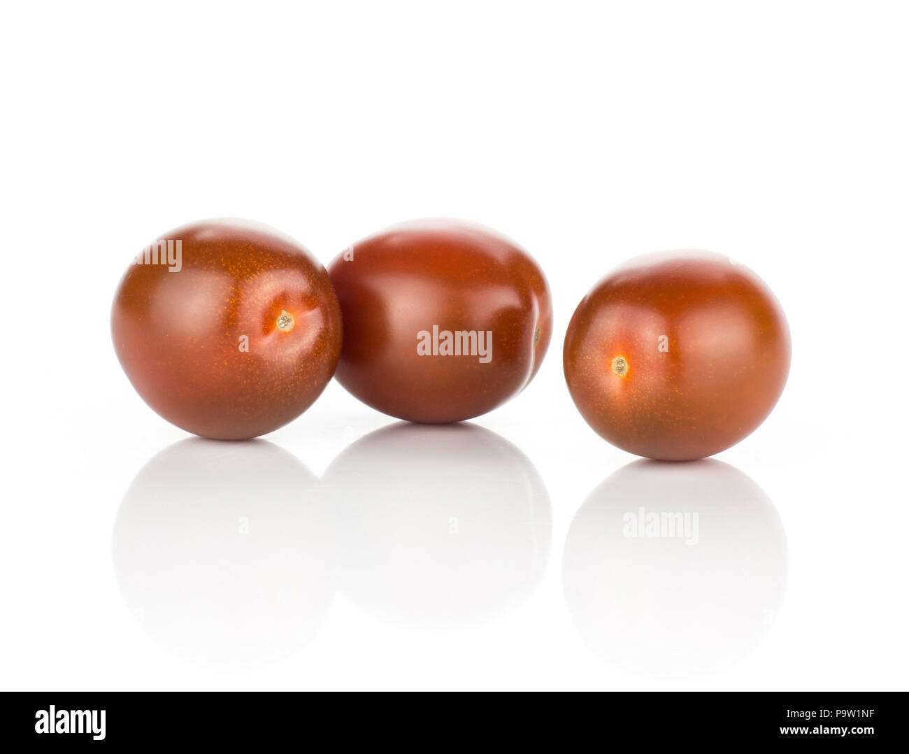 Three black red grape cherry tomatoes isolated on white background Stock Photo - Alamy