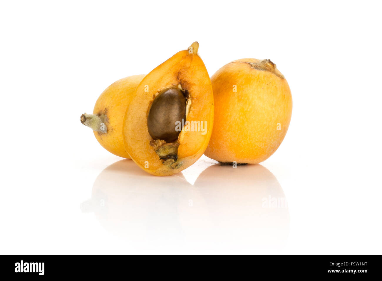 Fresh orange Japanese loquats two whole one half with seed isolated on ...