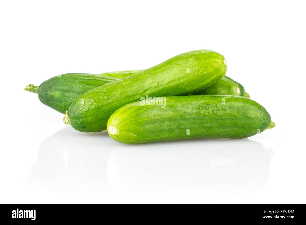 Three fresh green mini cucumbers set isolated on white background Stock ...