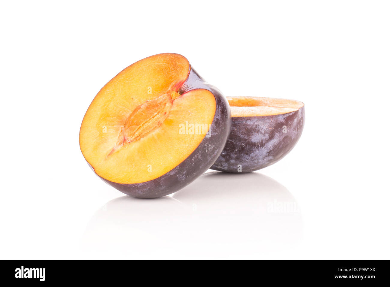 Sliced red blue plum isolated on white background one cut in two halves ...