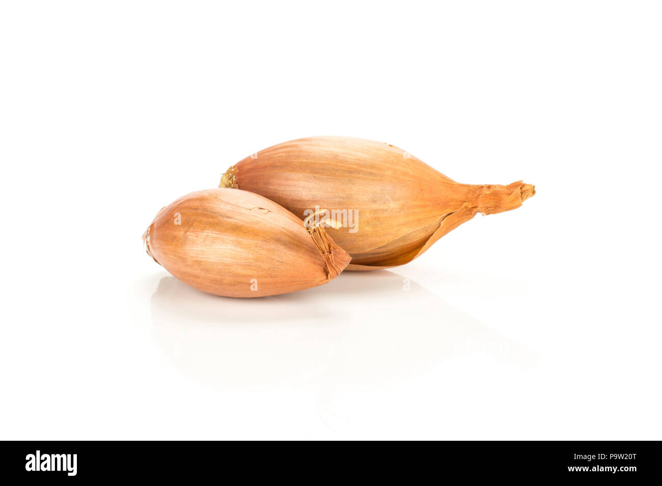 Two unpeeled golden shallots isolated on white background Stock Photo ...