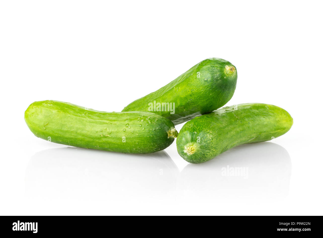 Three fresh green mini cucumbers isolated on white background Stock ...