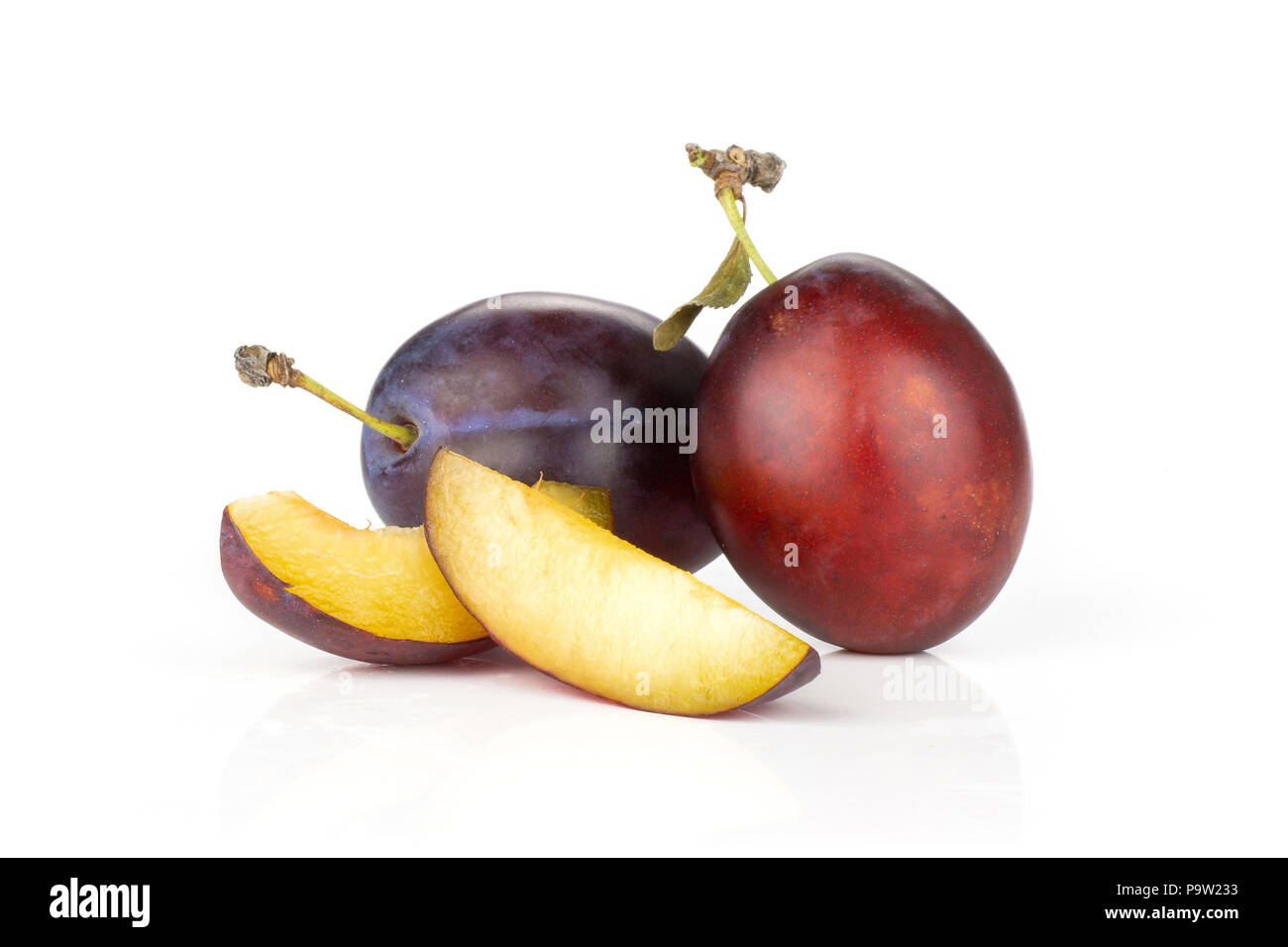 Group of two whole two slices of fresh violet-blue plum vibrant moyer ...
